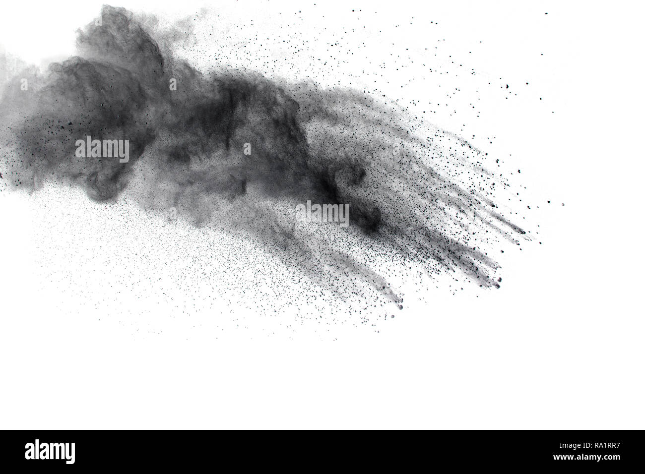 Black powder explosion. The particles of charcoal splatter on white ...