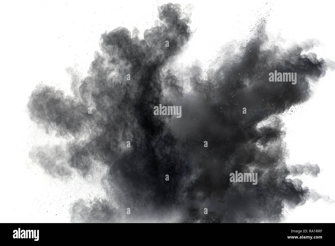 Black powder explosion. The particles of charcoal splatter on white ...