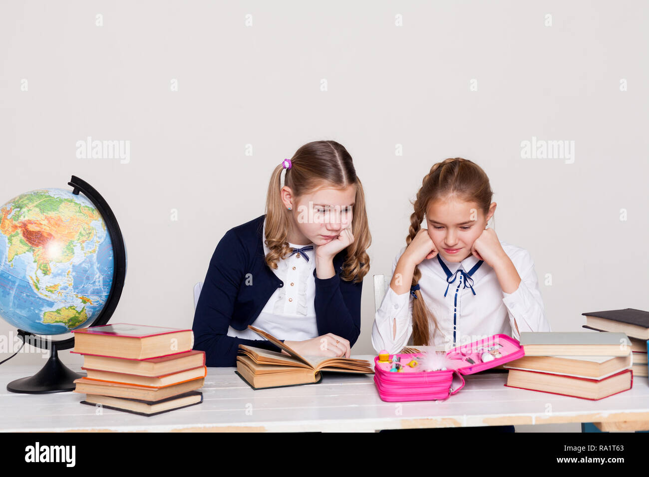 two girls schoolgirls sitting at his desk on the lesson at school Stock ...