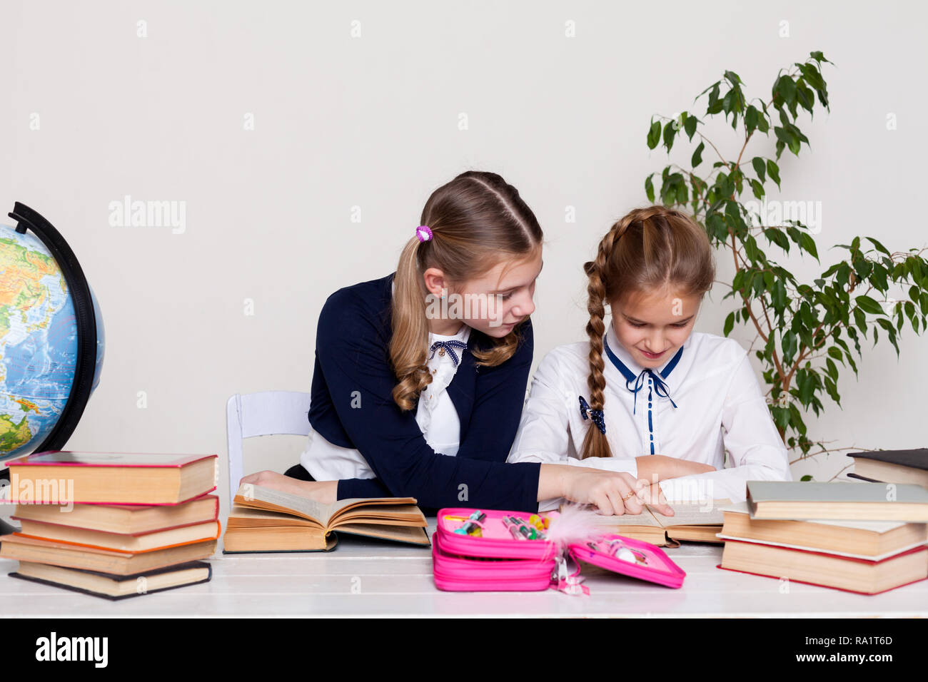 two girls schoolgirls sitting at his desk on the lesson at school Stock ...