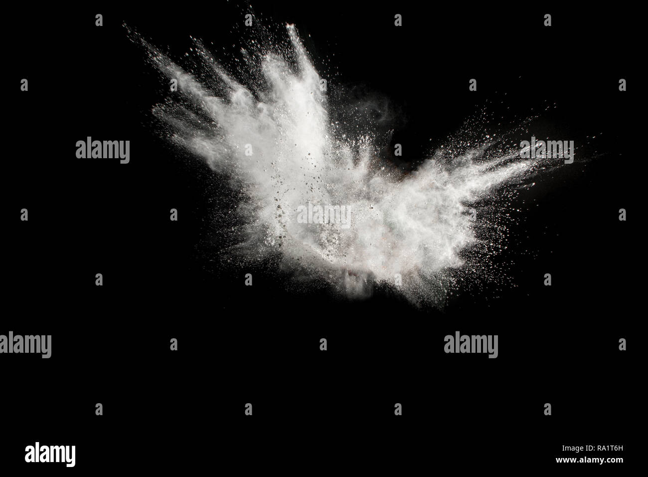 Launched white powder splash on black background Stock Photo - Alamy