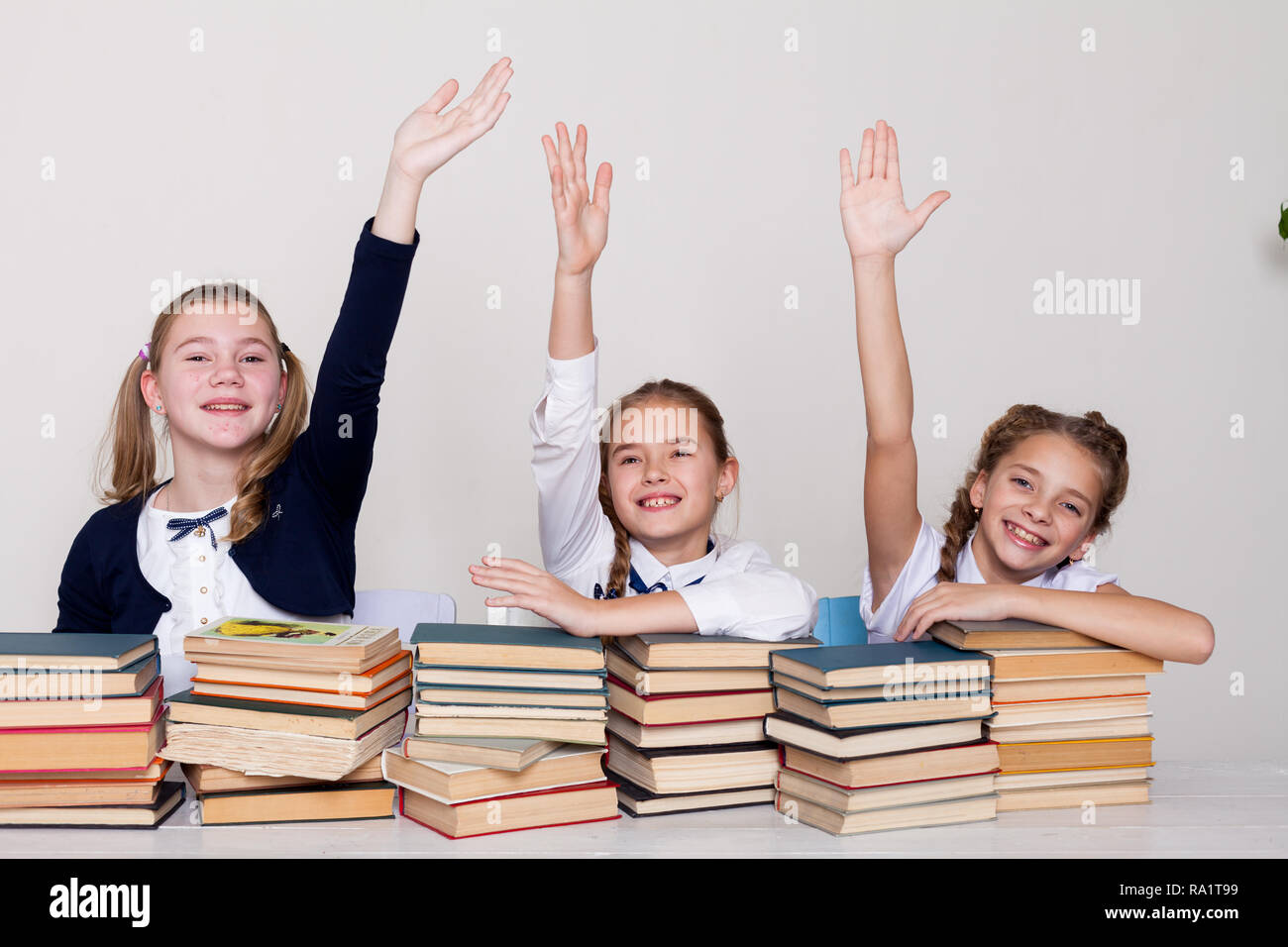 two girls schoolgirls sit with books at his desk on the lesson at ...