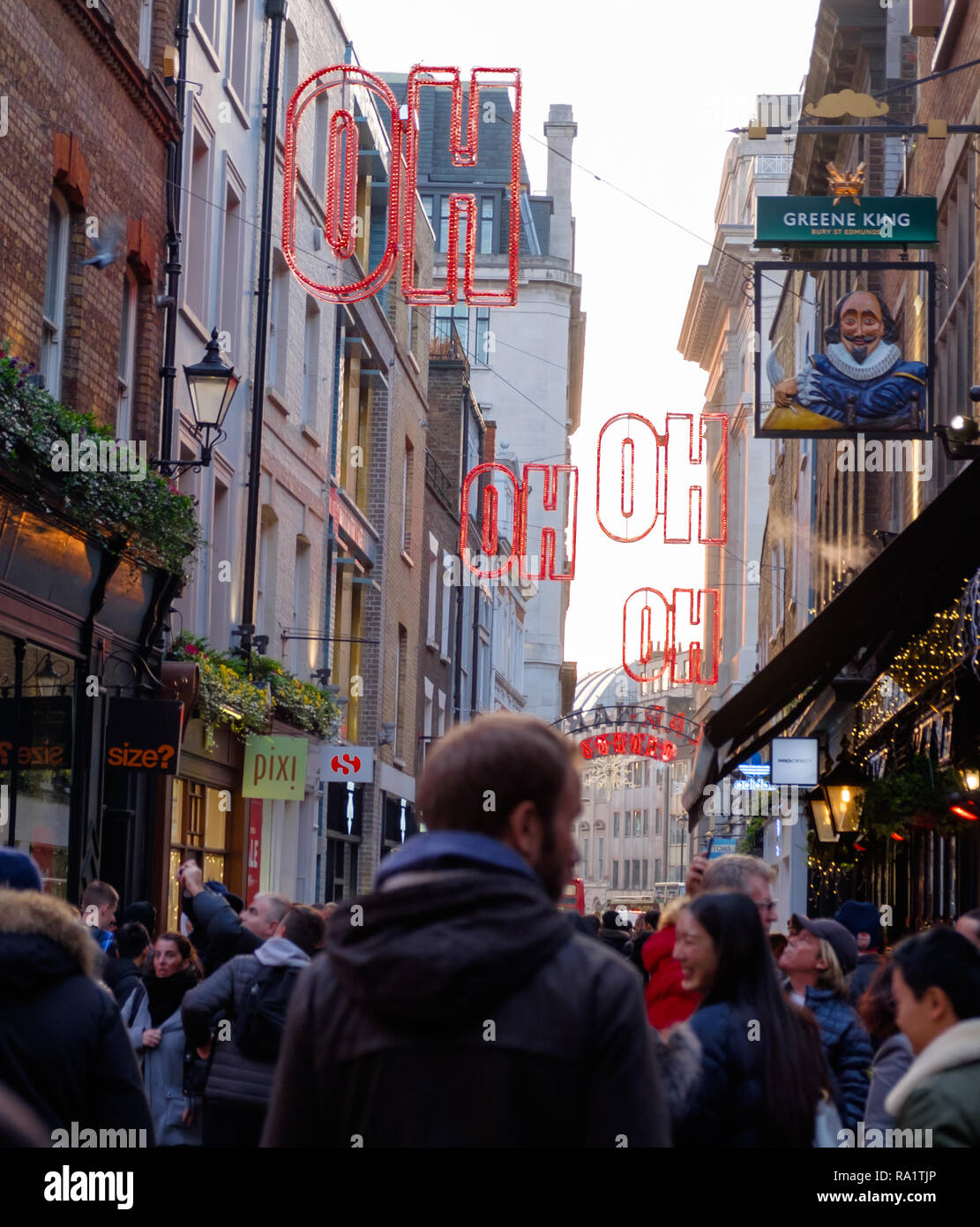 Shoppers on Carnaby Street, Soho, London under Christmas Neon Light ...