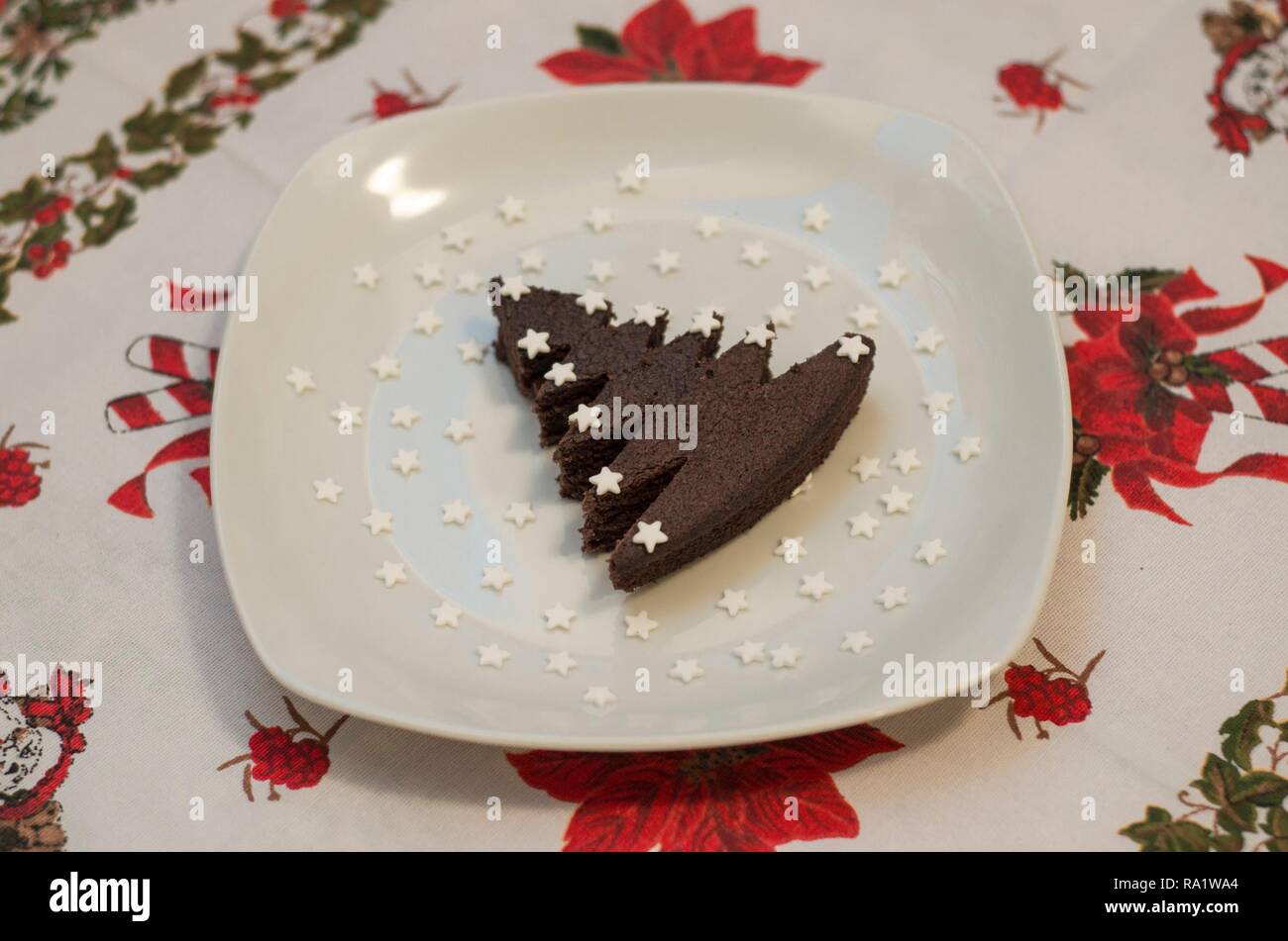Christmas tree shaped chocolate cake with sugar stars Stock Photo - Alamy