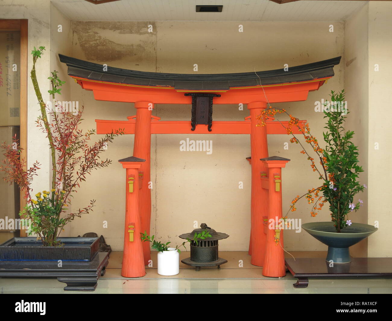 An essentially Japanese still life with model red torii gate, lanterns ...