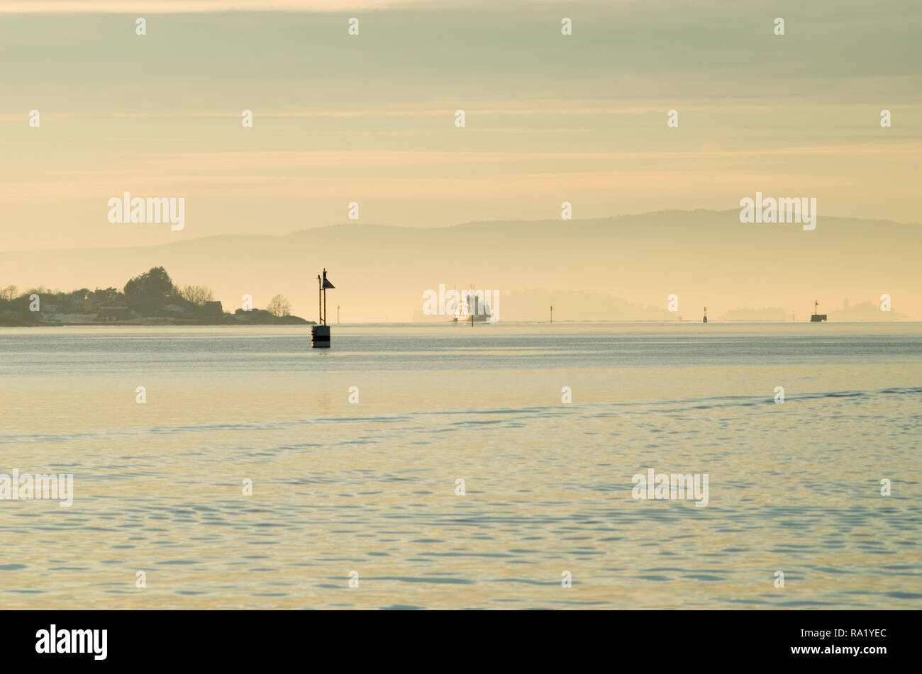 Local ferry boat en route to Oslo in golden light of calm sunset in ...