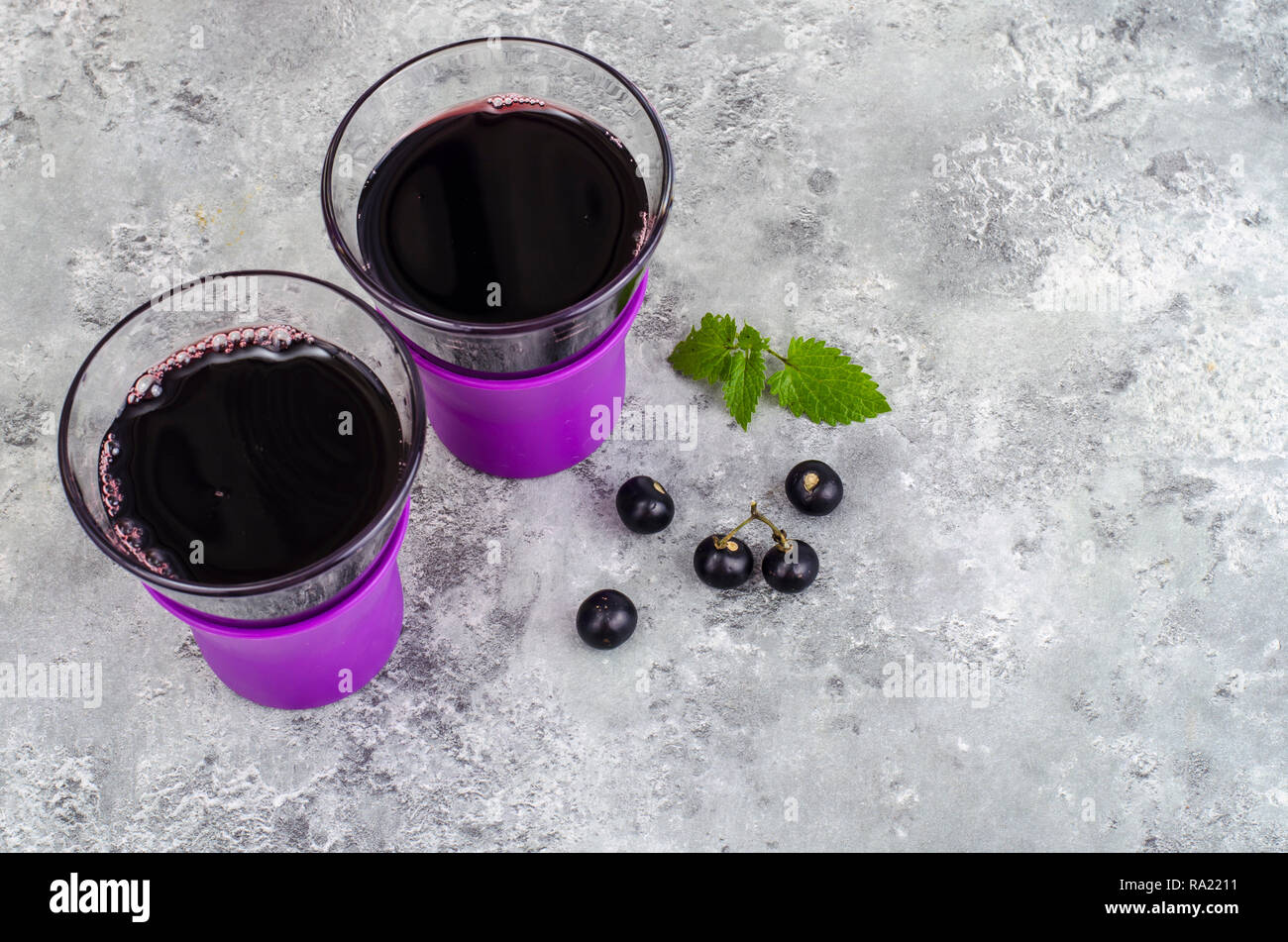 Natural juice of dark berries in glass. Studio Photo Stock Photo - Alamy