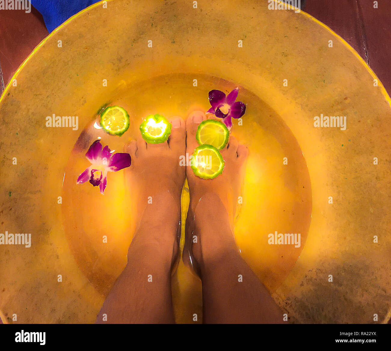 Golden foot soak at exotic spa resort Stock Photo - Alamy