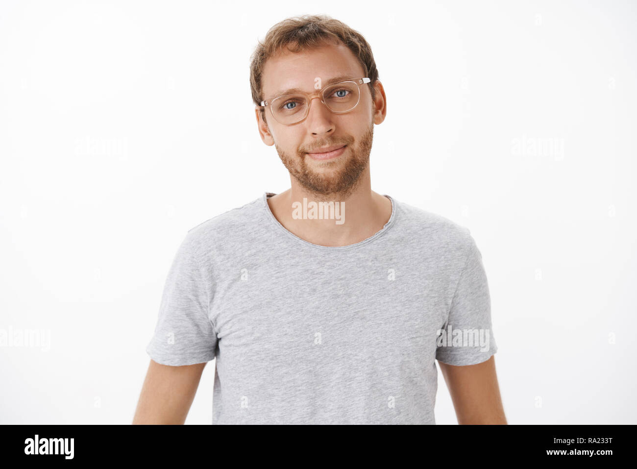 Waist-up shot of cute friendly and handsome male european with beard in ...