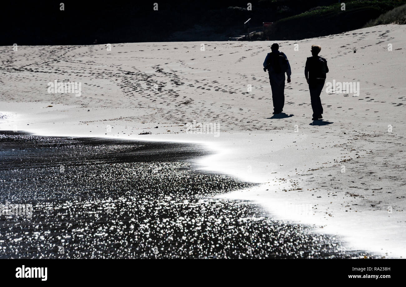 Silhouettes hiking on the beach Stock Photo - Alamy