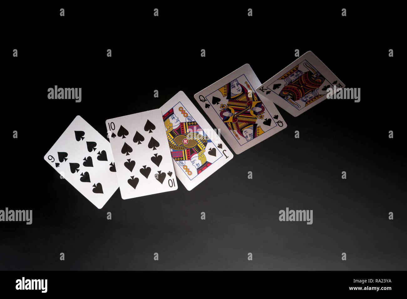 flying playing cards on a dark background-Royal Flush Stock Photo - Alamy