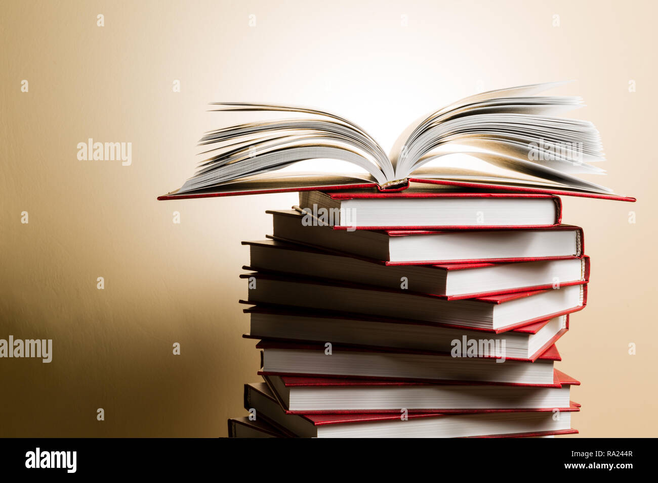 An open book on a stack of red books in the form of a spiral Stock ...