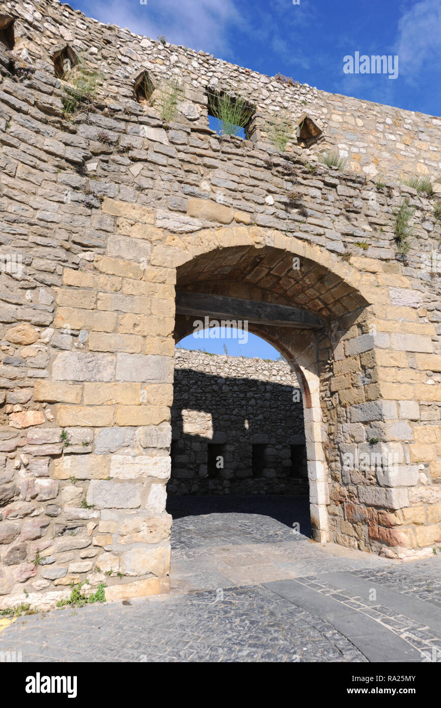 A gateway arched entrance over a cobbled street through the city wall ...