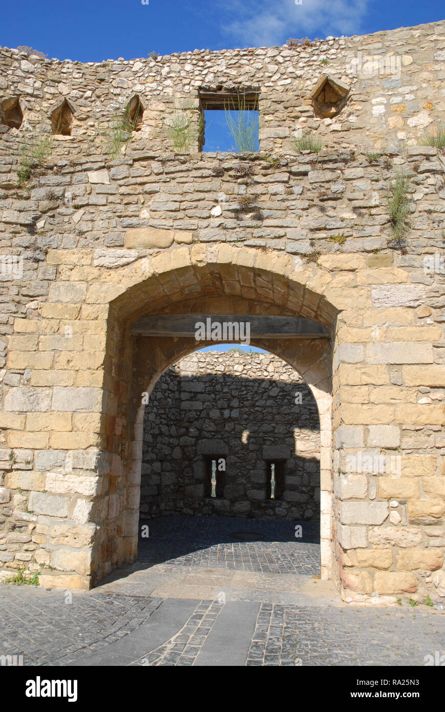 A gateway arched entrance over a cobbled street through the city wall ...