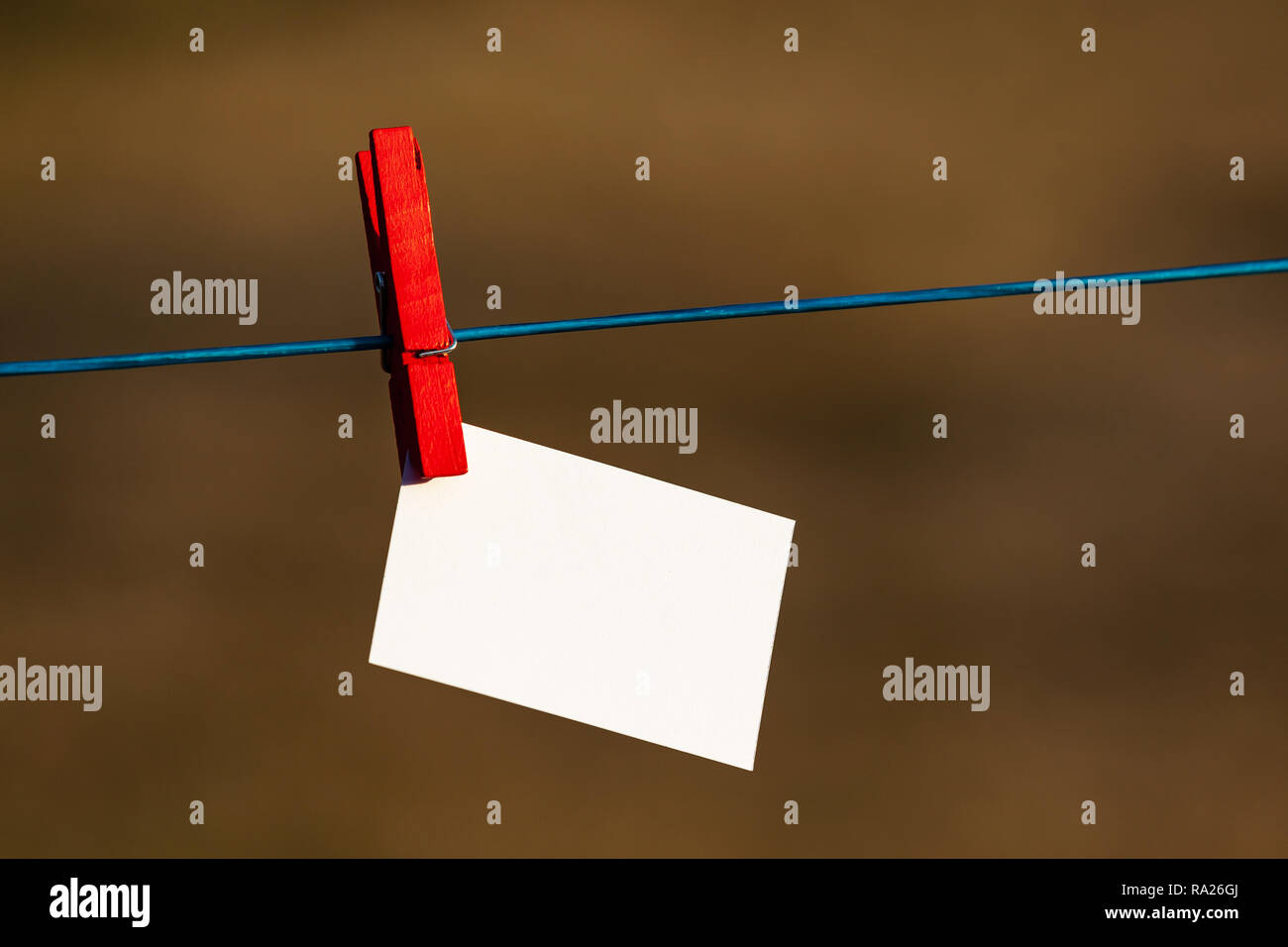 Red peg and a card on a washing line Stock Photo - Alamy