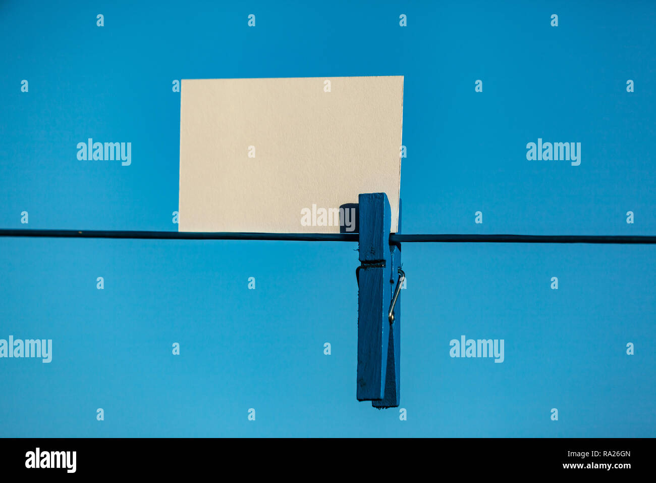 Blue peg holding a card (can add own text Stock Photo - Alamy