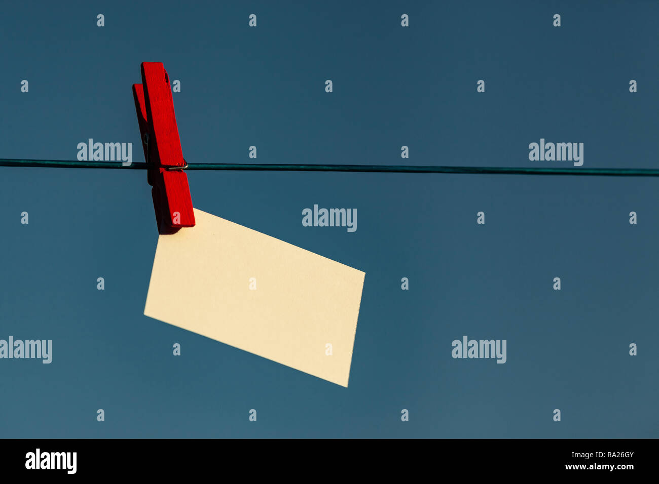 Red peg and a card on a washing line Stock Photo - Alamy
