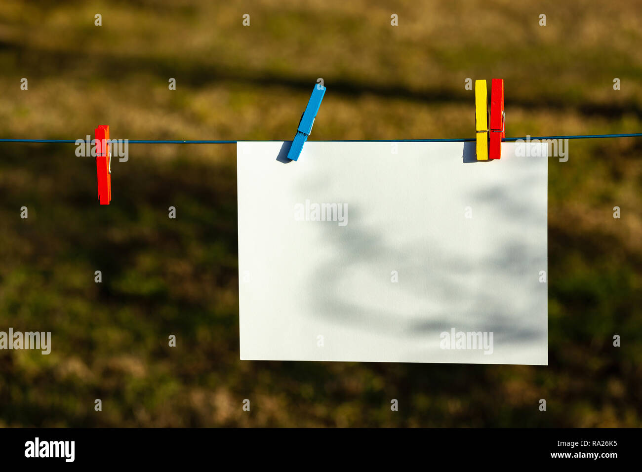 Coloured pegs and paper Stock Photo - Alamy