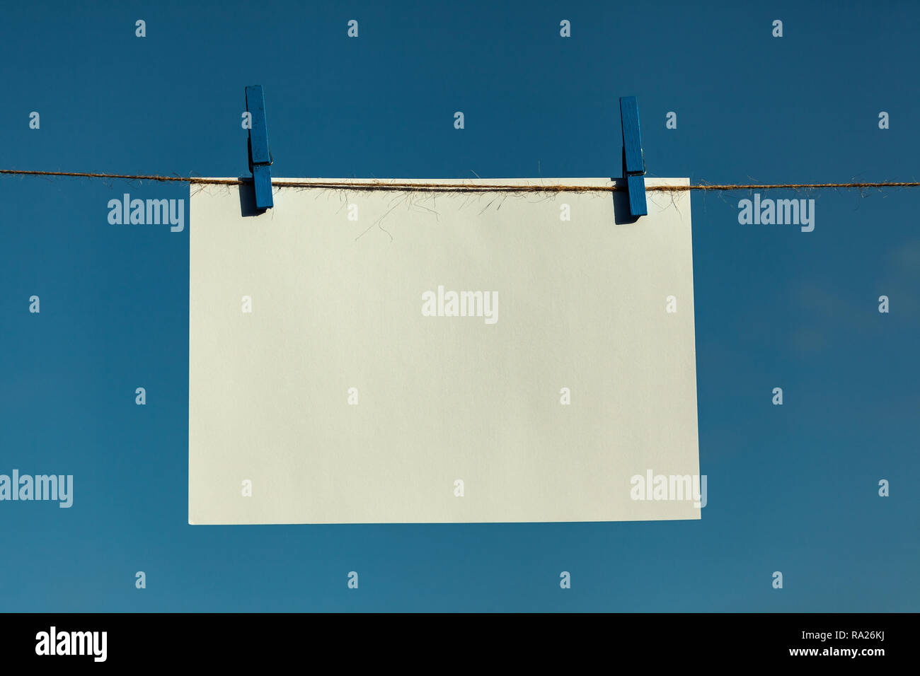 Pegs and paper on a line Stock Photo - Alamy