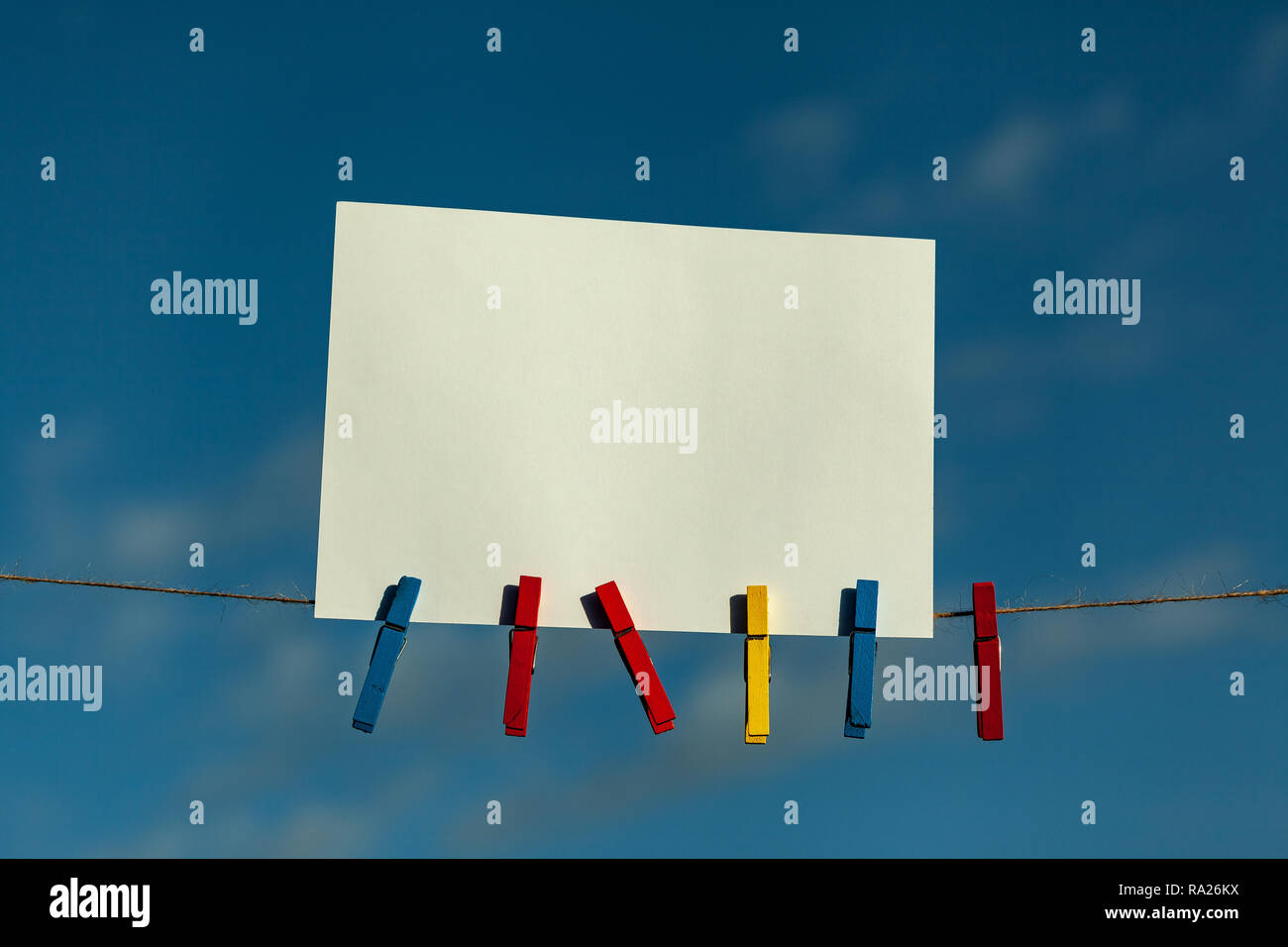 Coloured pegs and paper Stock Photo - Alamy