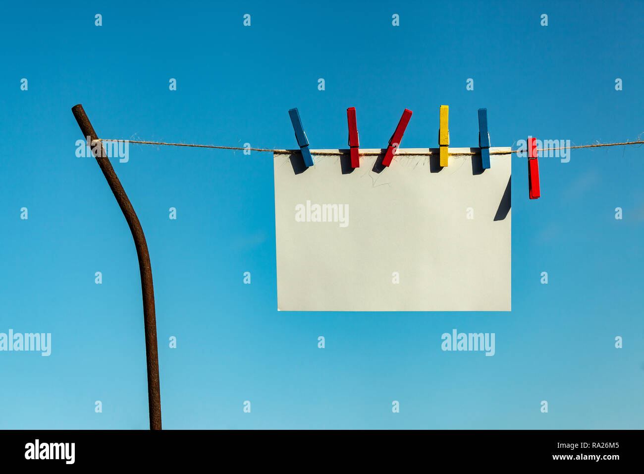 Coloured pegs and paper Stock Photo - Alamy