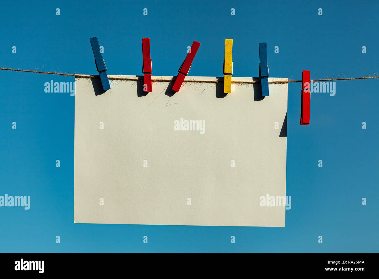 Coloured pegs and paper Stock Photo - Alamy
