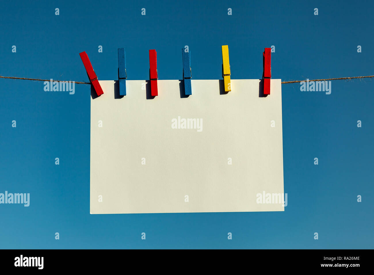 Coloured pegs and paper Stock Photo - Alamy