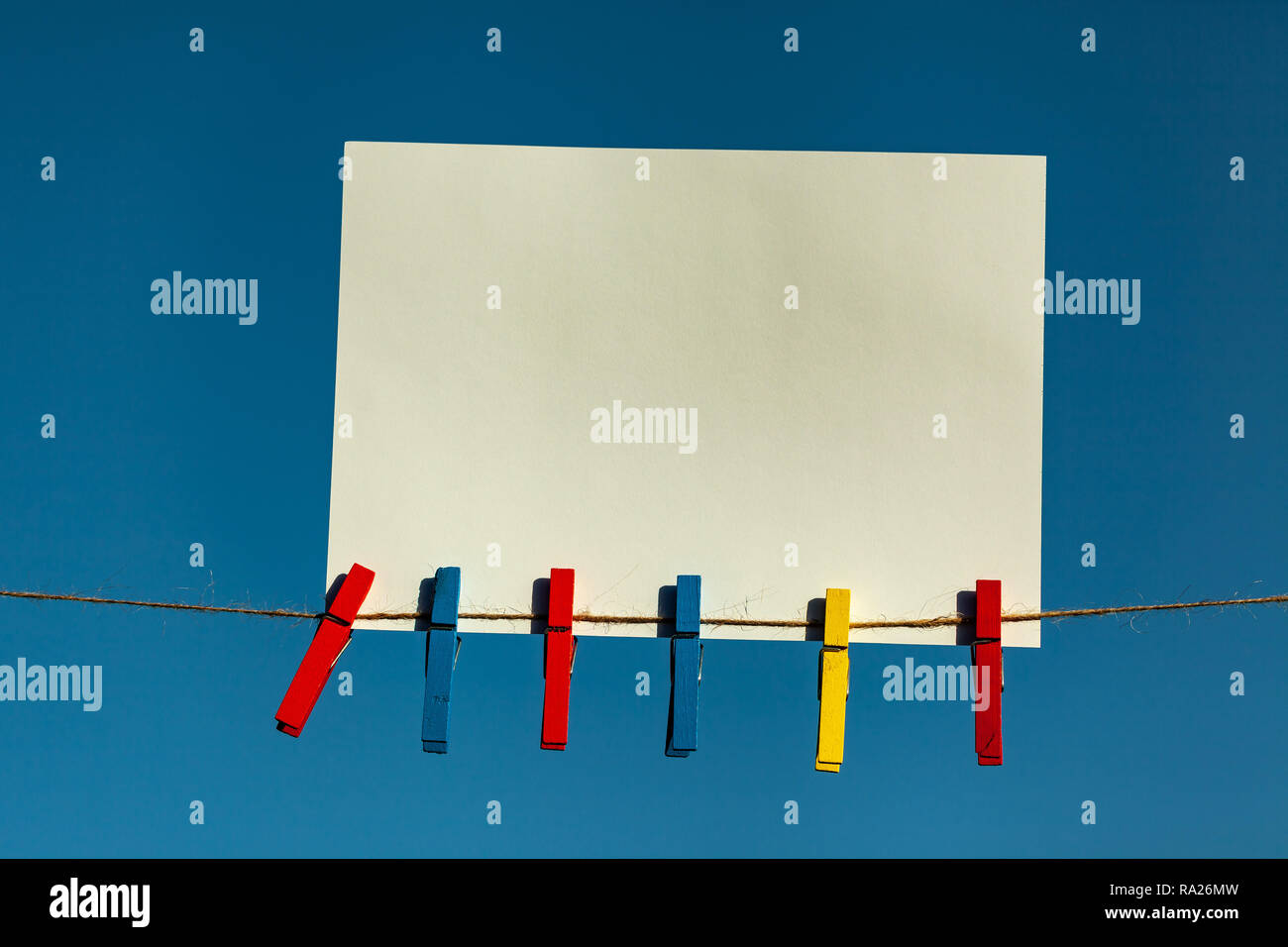 Coloured pegs and paper Stock Photo - Alamy