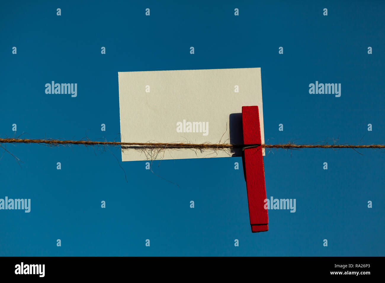 Red peg and a card on a washing line Stock Photo - Alamy