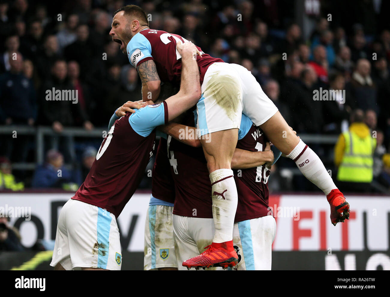 Burnley's Dwight McNeil (hidden) celebrates scoring his side's second ...