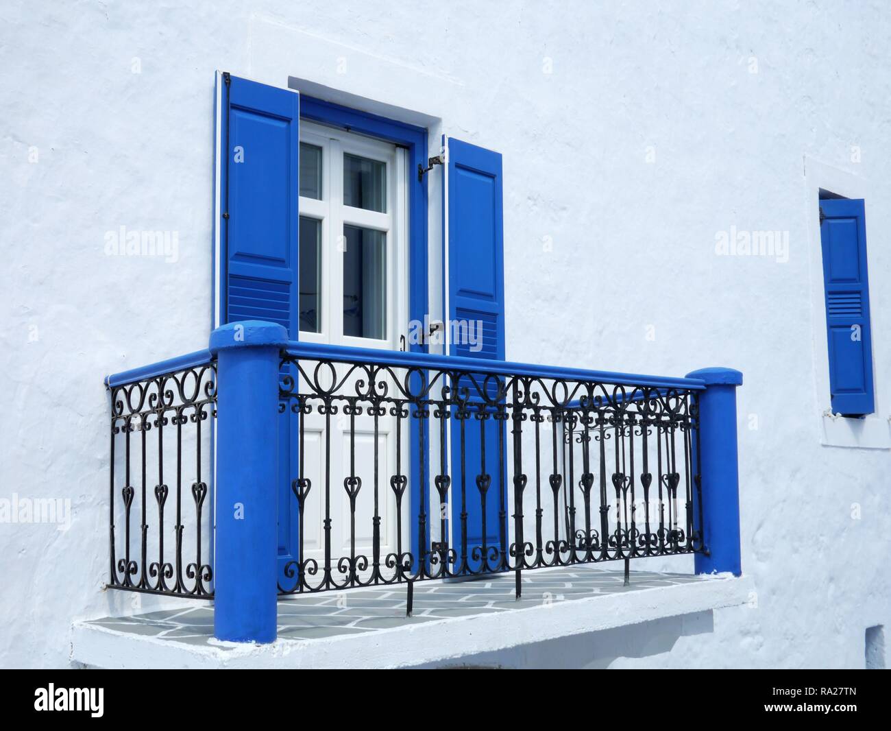 Traditional Whitewashed Greek Home with a Blue Balcony with Shutters ...
