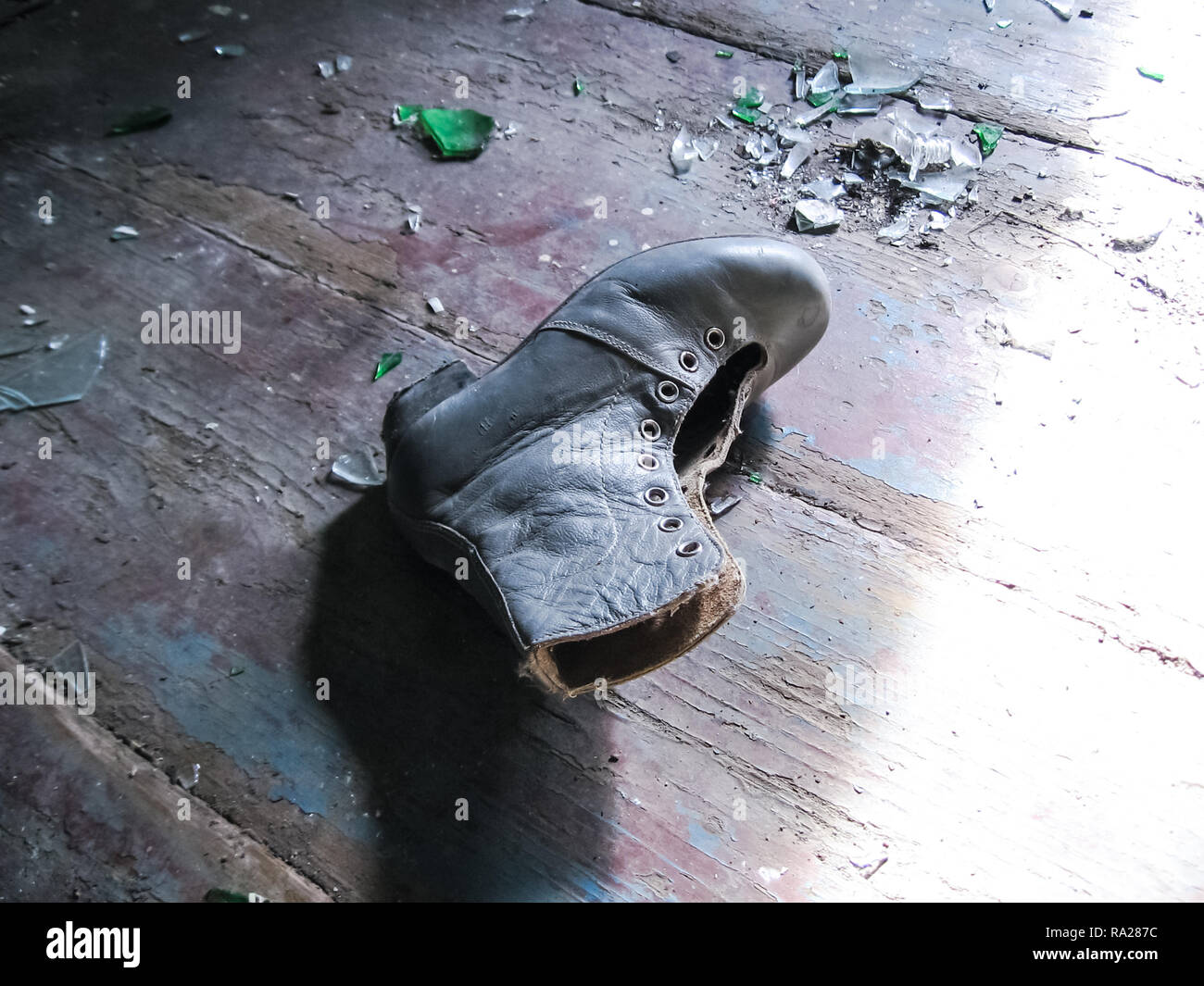 Old discarded shoes on the floor. Abandoned house Stock Photo - Alamy