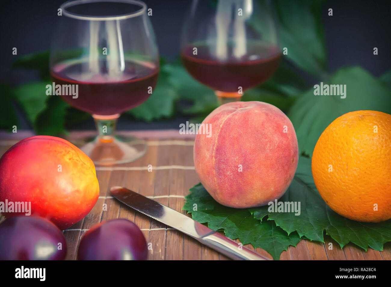 Still life: wine by the glass and fruit Stock Photo - Alamy