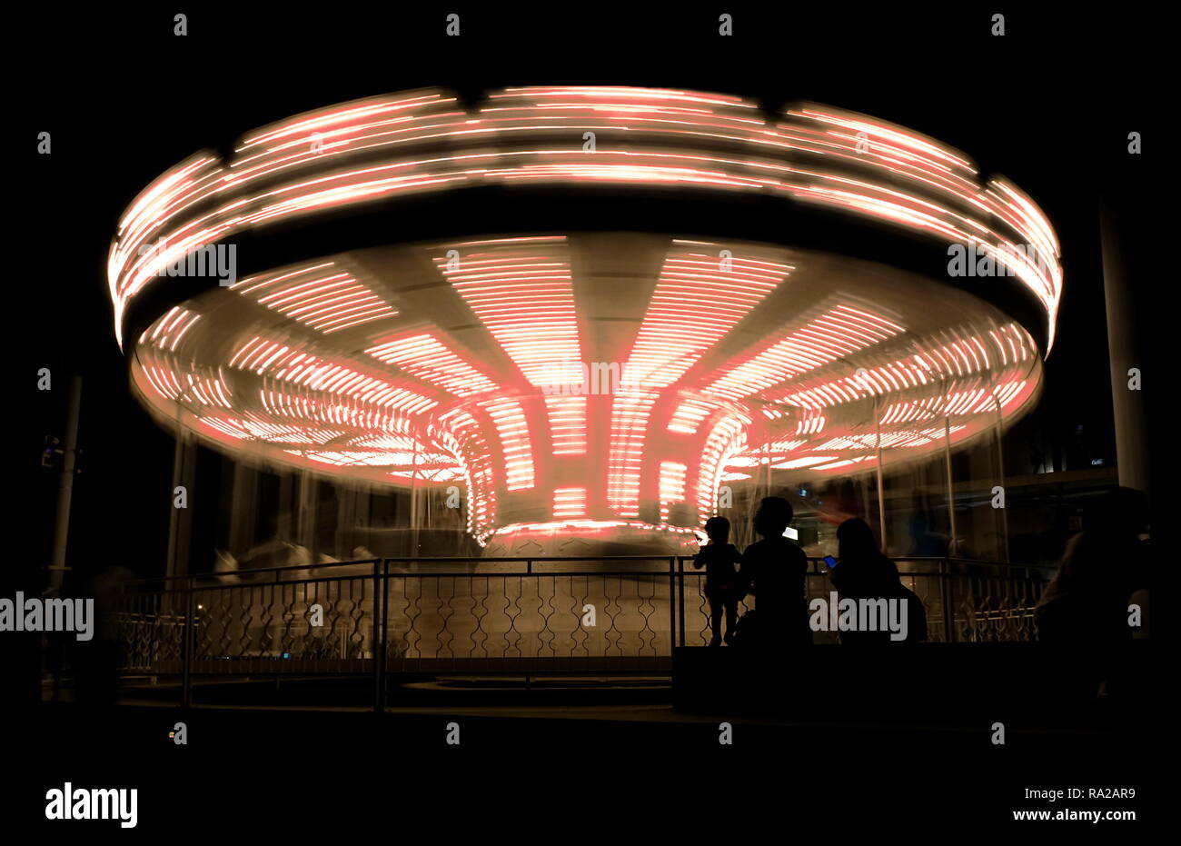 Image of a carousel in long time exposure creating rotating motion ...
