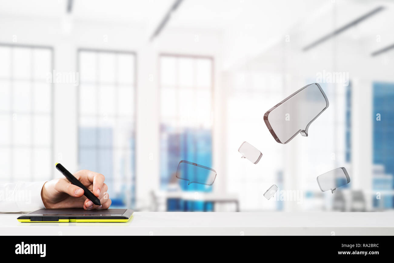 Male hands using graphics tablet and glass icons fly in air. Mixed ...
