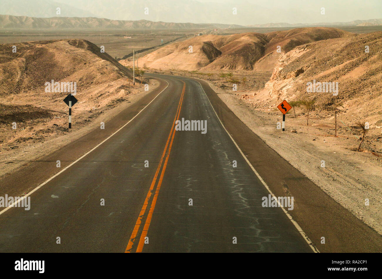 Serpentine mountain road with road signs, Peru, South America Stock ...