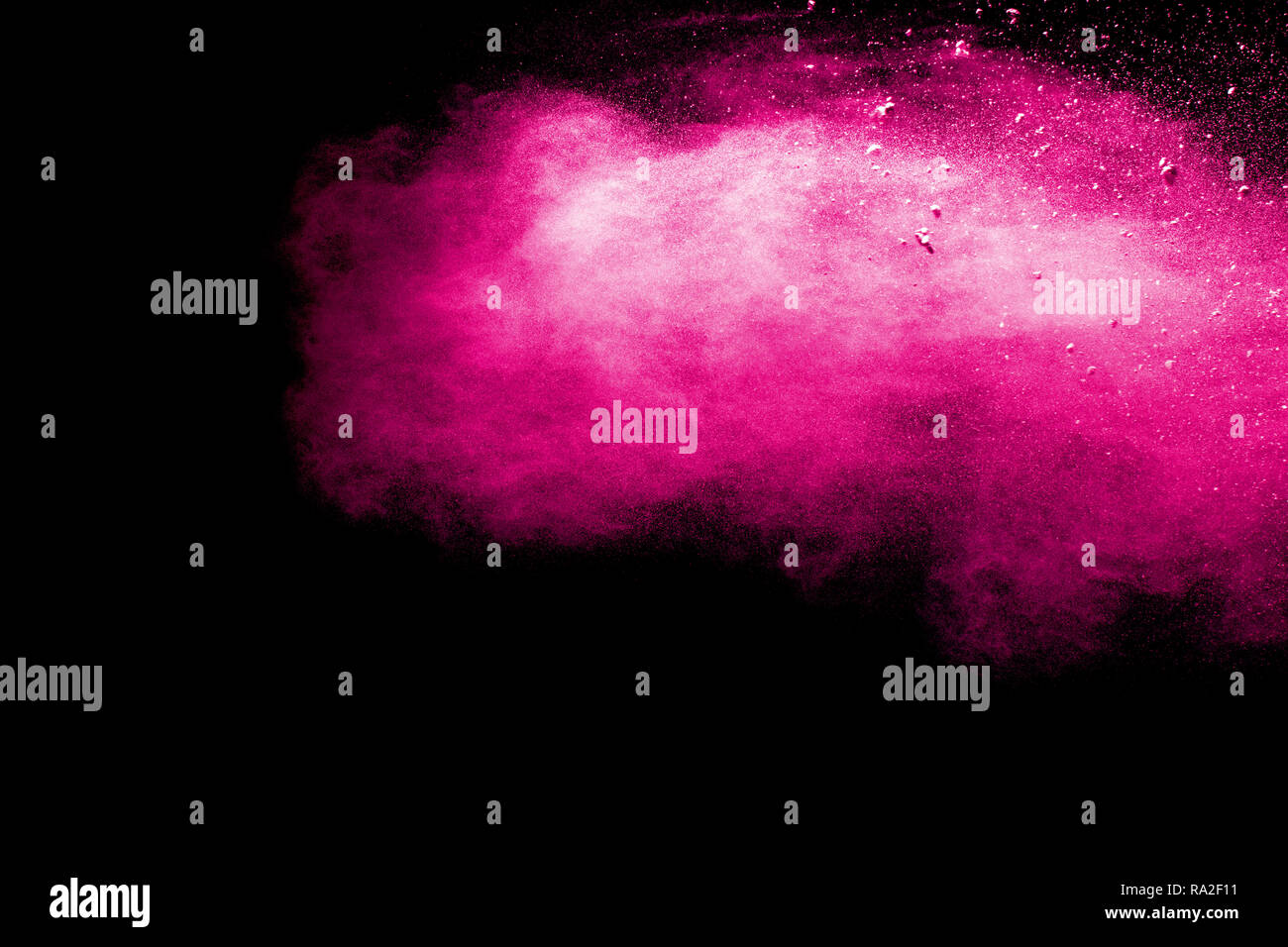 abstract pink dust explosion on black background.abstract pink powder ...