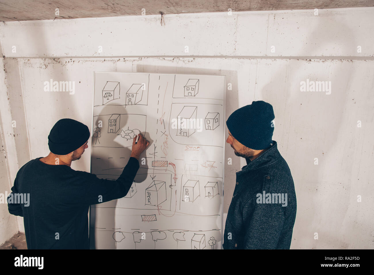 Criminals wearing black are standing and making a plan for robbery ...