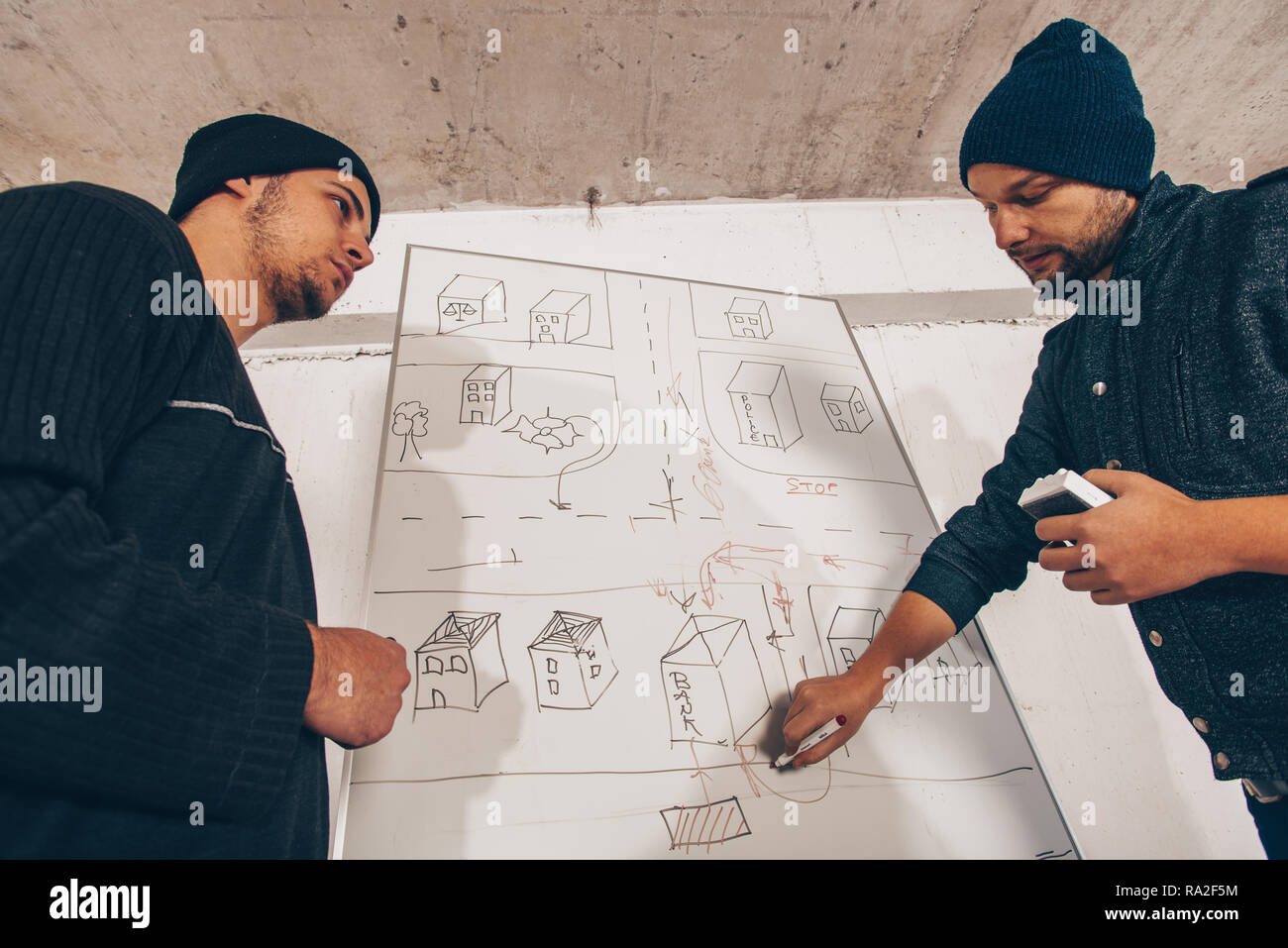 Housebreakers standing near the map and planning a crime Stock Photo ...