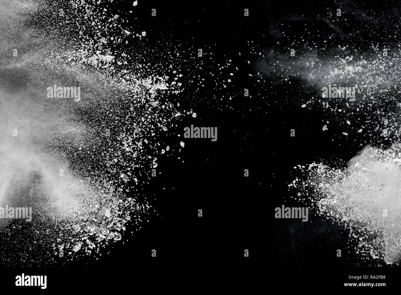 Bizarre forms of white powder explosion cloud against black background ...