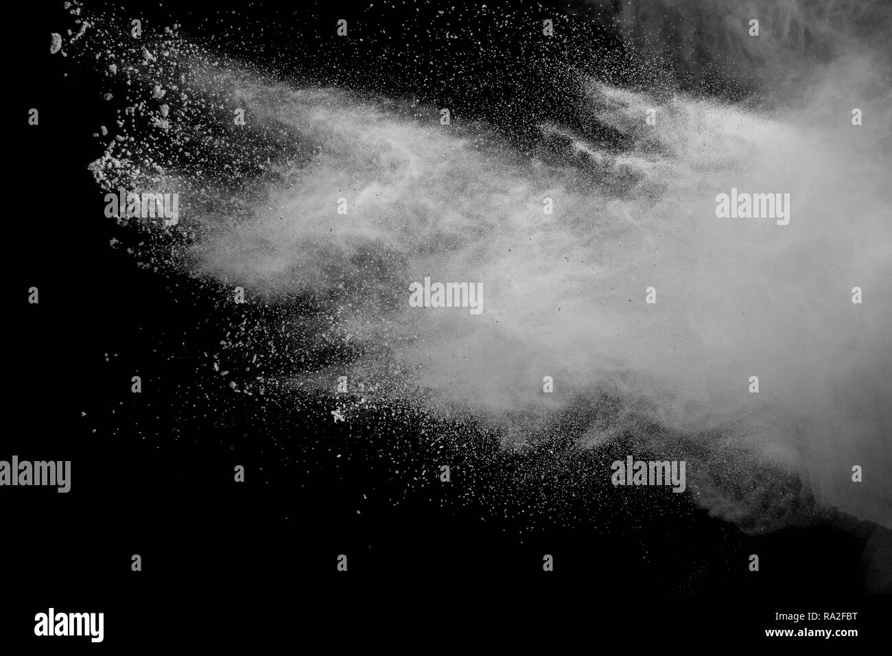 White talcume powder explosion on black background. White dust ...