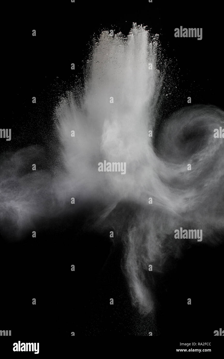 White talcume powder explosion on black background. White dust ...