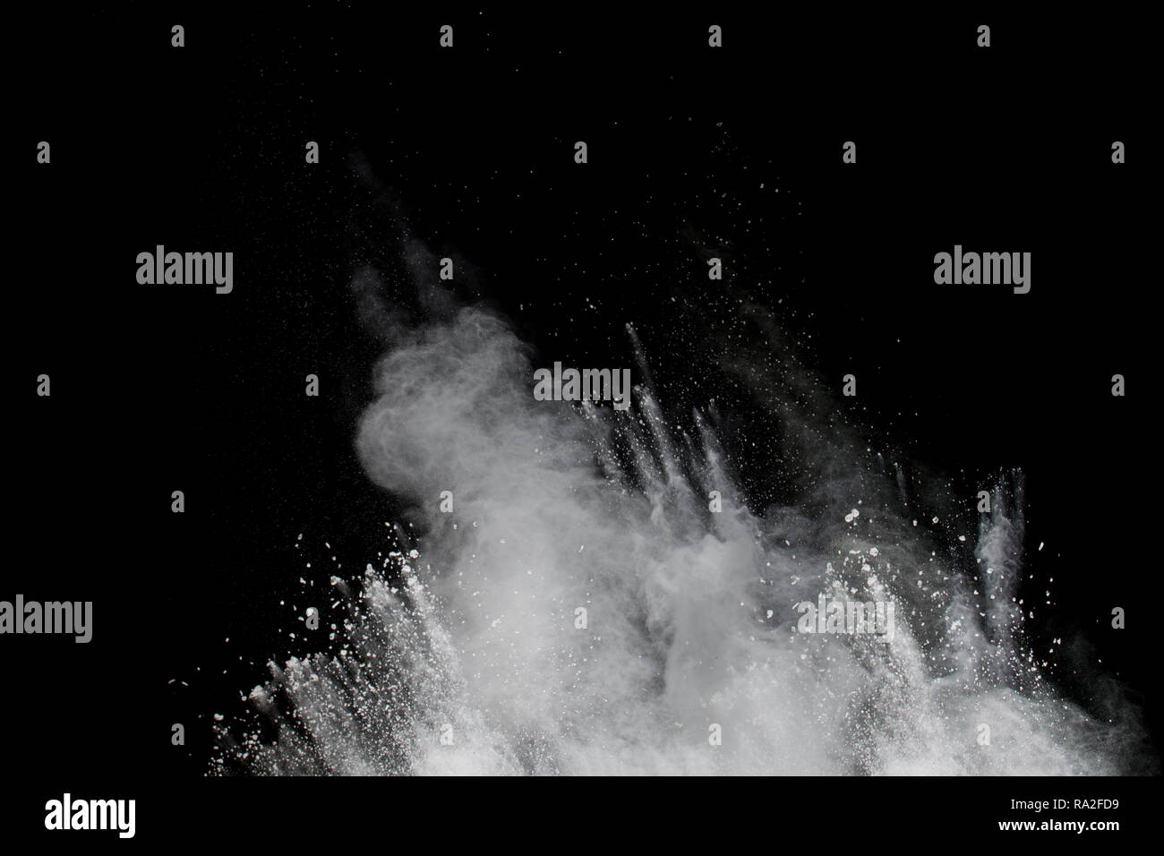 White talcume powder explosion on black background. White dust ...