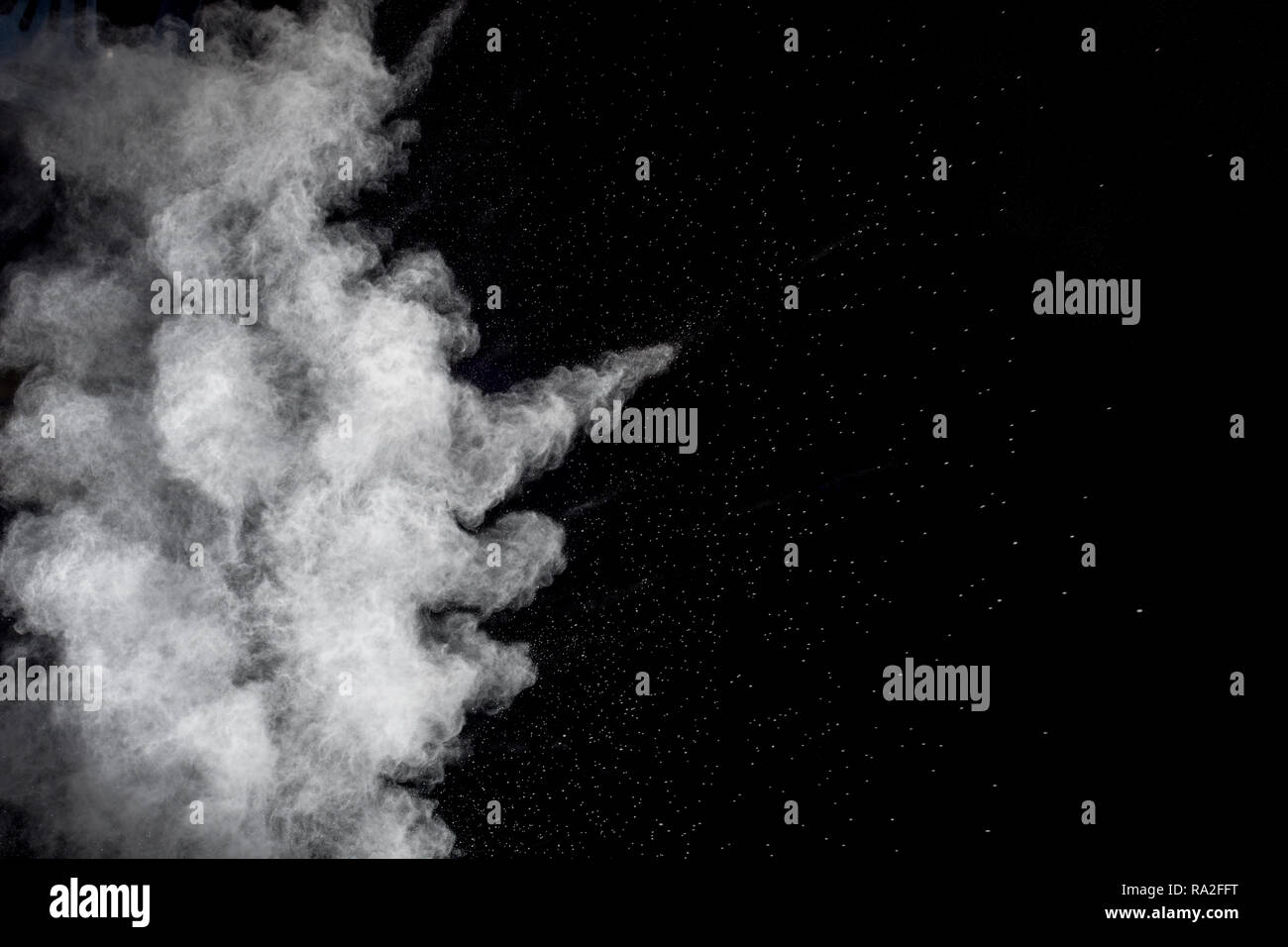 Bizarre forms of white powder explosion cloud against black background ...