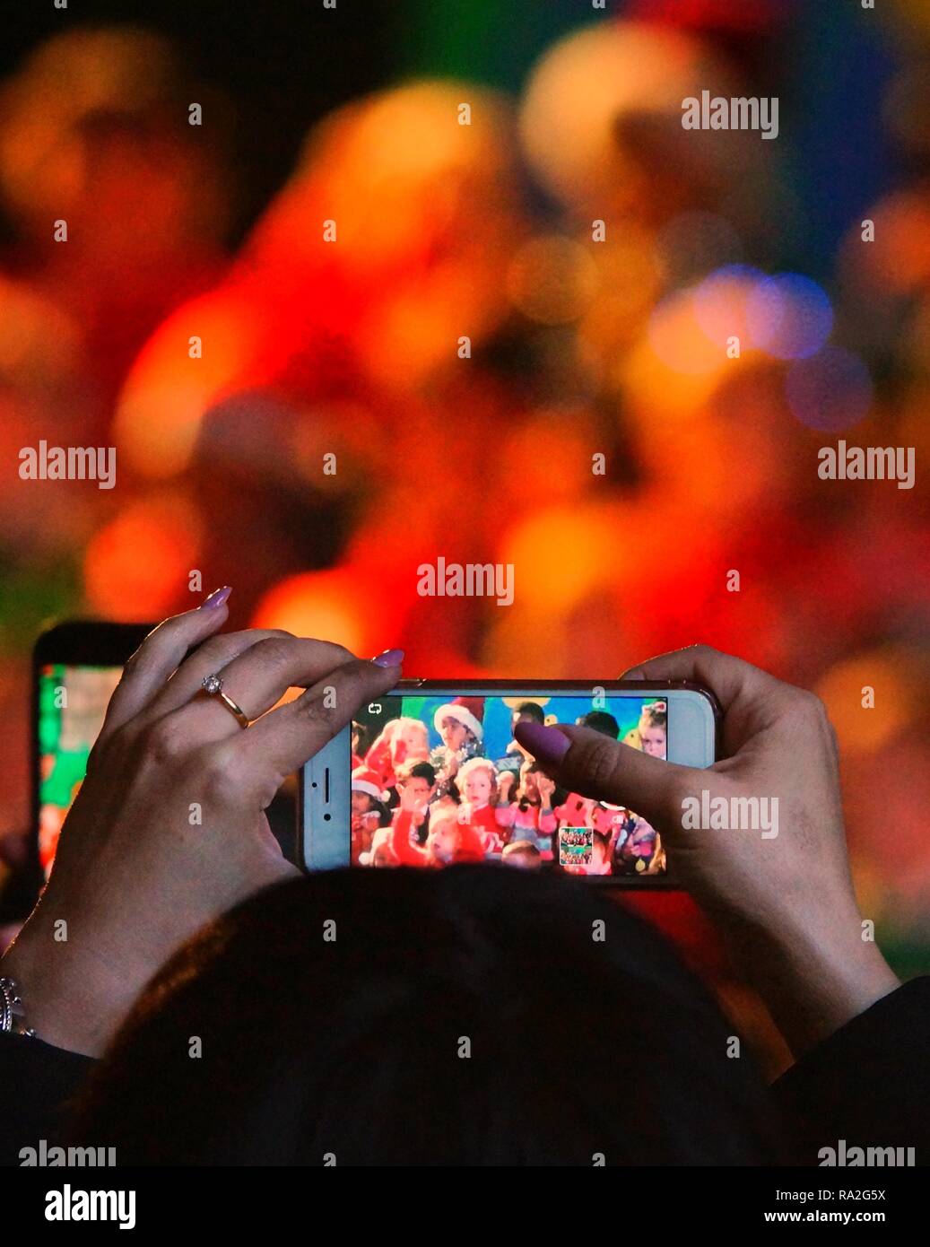 Parent recording their children during a nativity play at Christmas ...