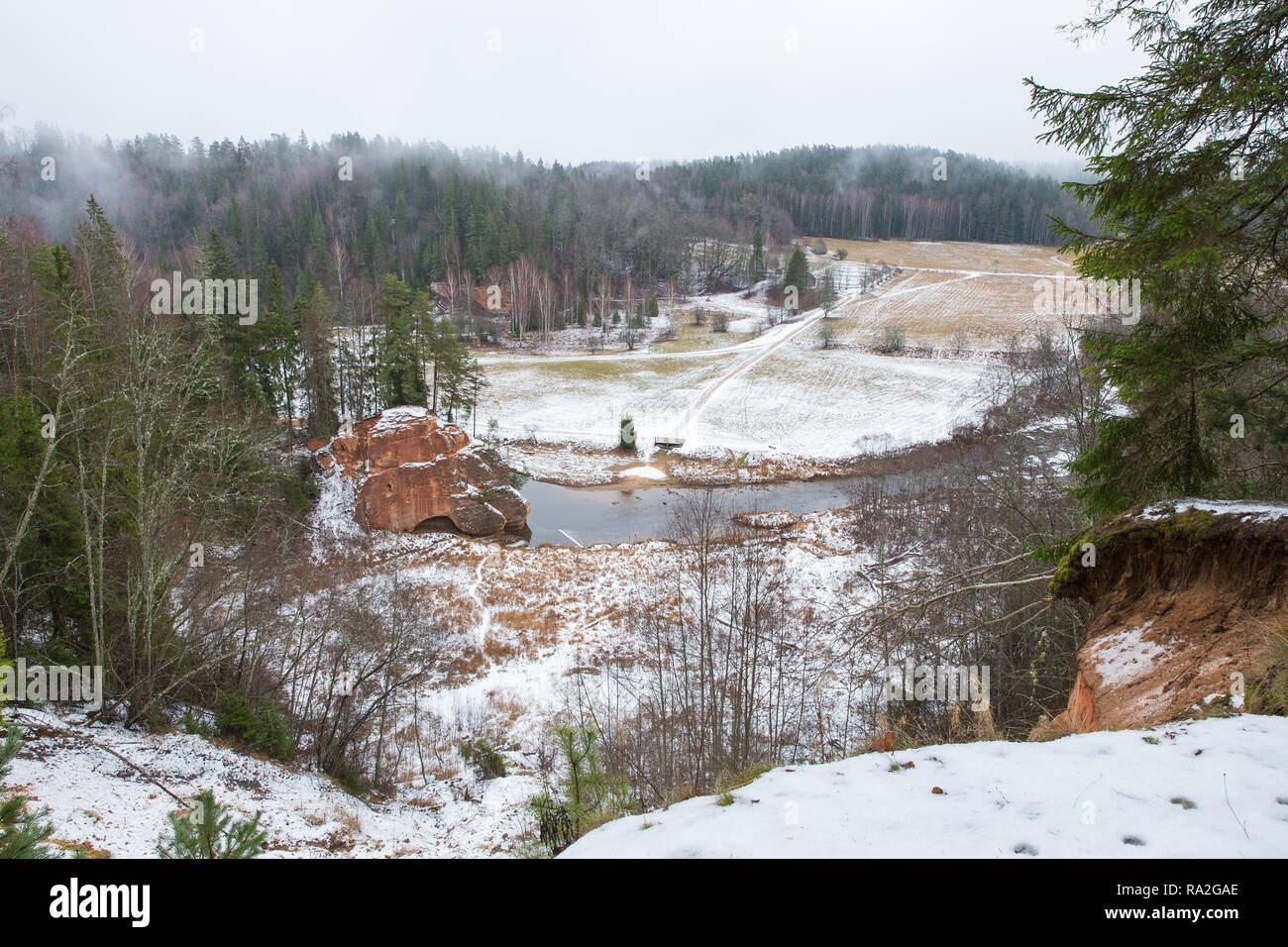City Cesis, Latvia, river Amata. Red cliffs and river in winter. Snow ...