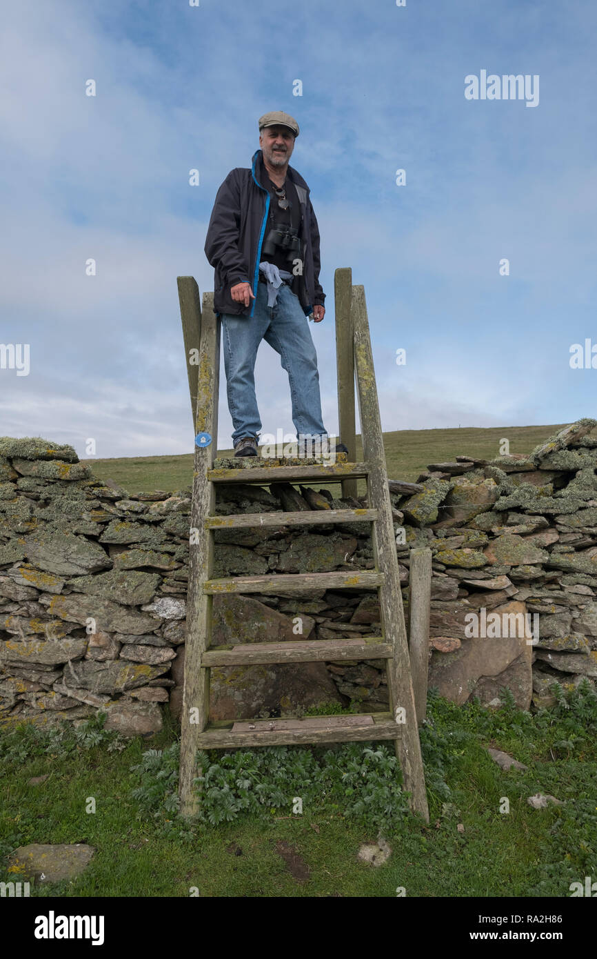 Man climbing over wall hi-res stock photography and images - Alamy