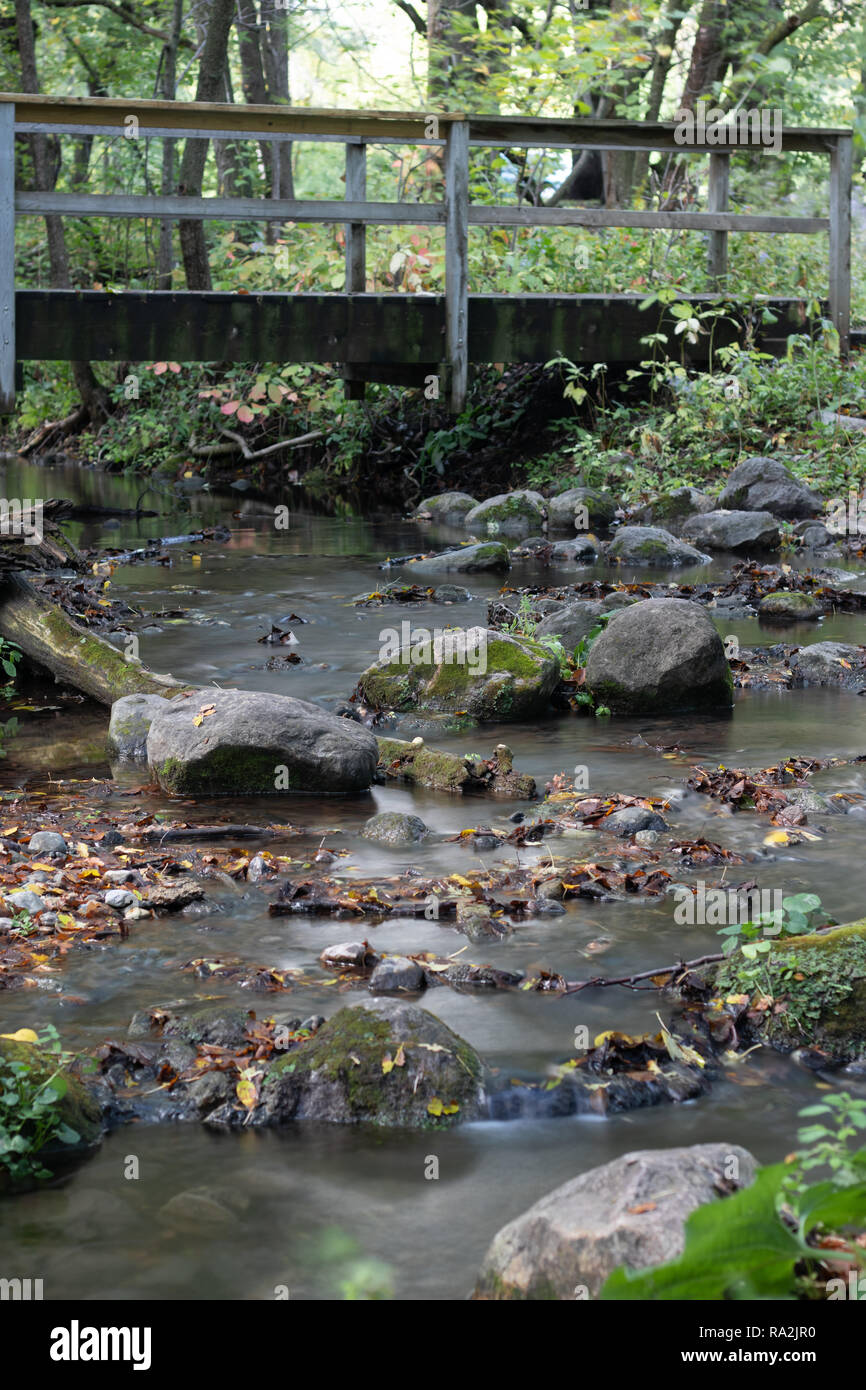 Bridge over small stream Stock Photo - Alamy