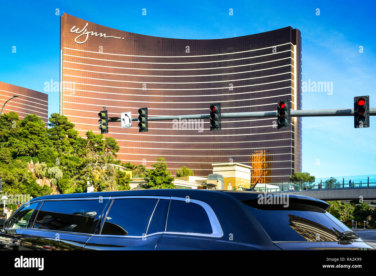 Black stretch limousine makes a turn at traffic lights in front of the ...