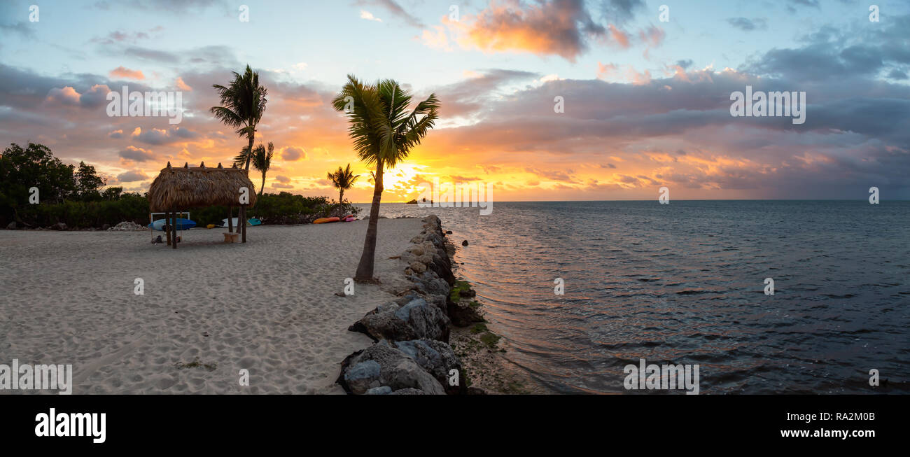 Striking sunrise viewed on a tropical sandy beach at the Atlantic Ocean ...